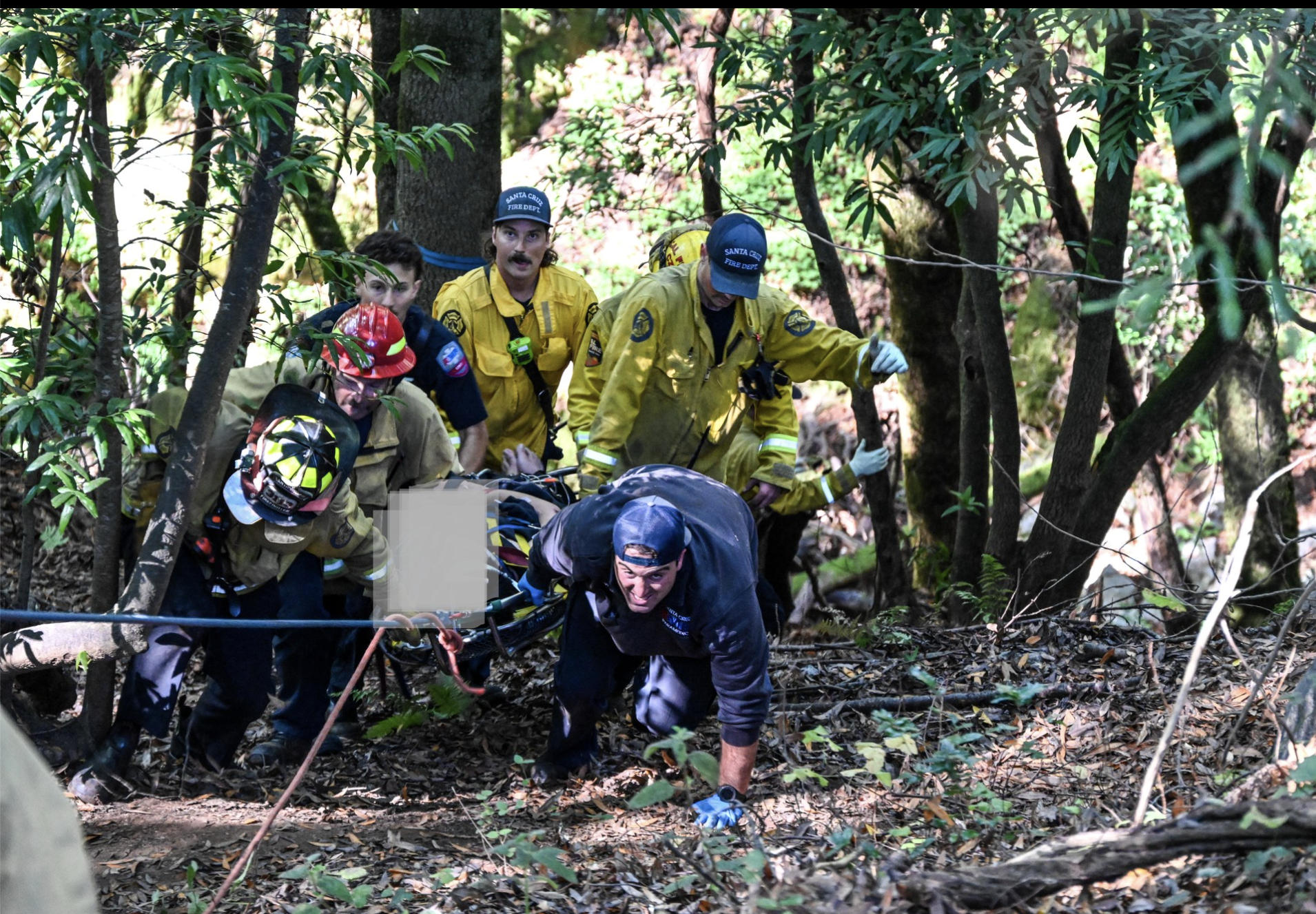 First responders pull injured victim out of wooded area in cliff rescue ...